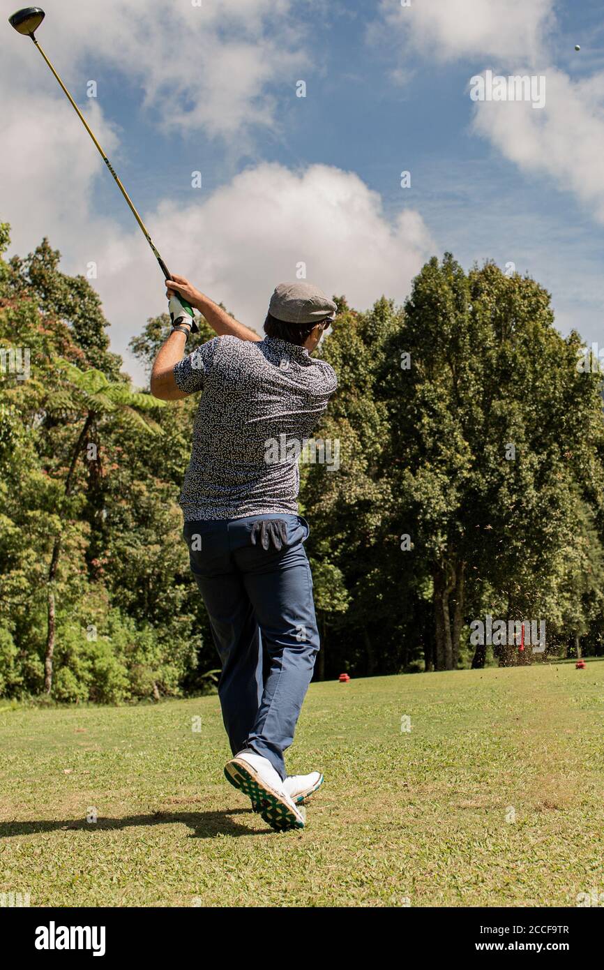 A man flying through the air on a golf course. High quality photo Stock ...