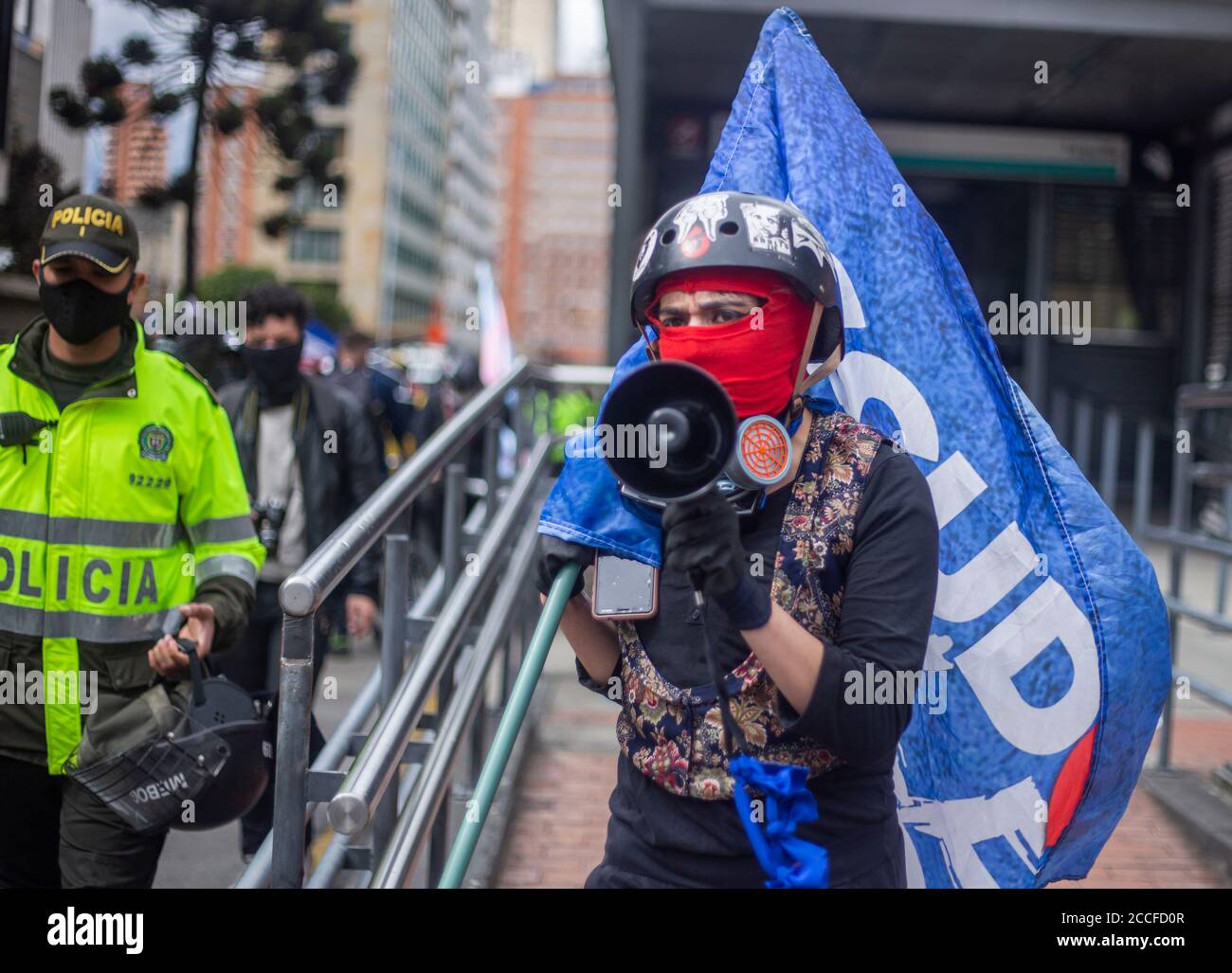 Bogota, Colombia. 21st Aug, 2020. A woman with her face covered marches ...