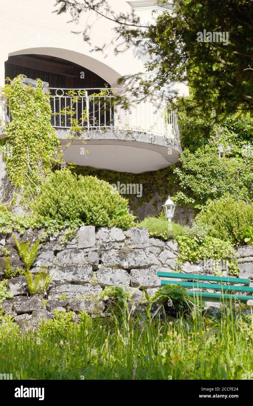 Rock garden with garden bench in front of balcony hi-res stock ...