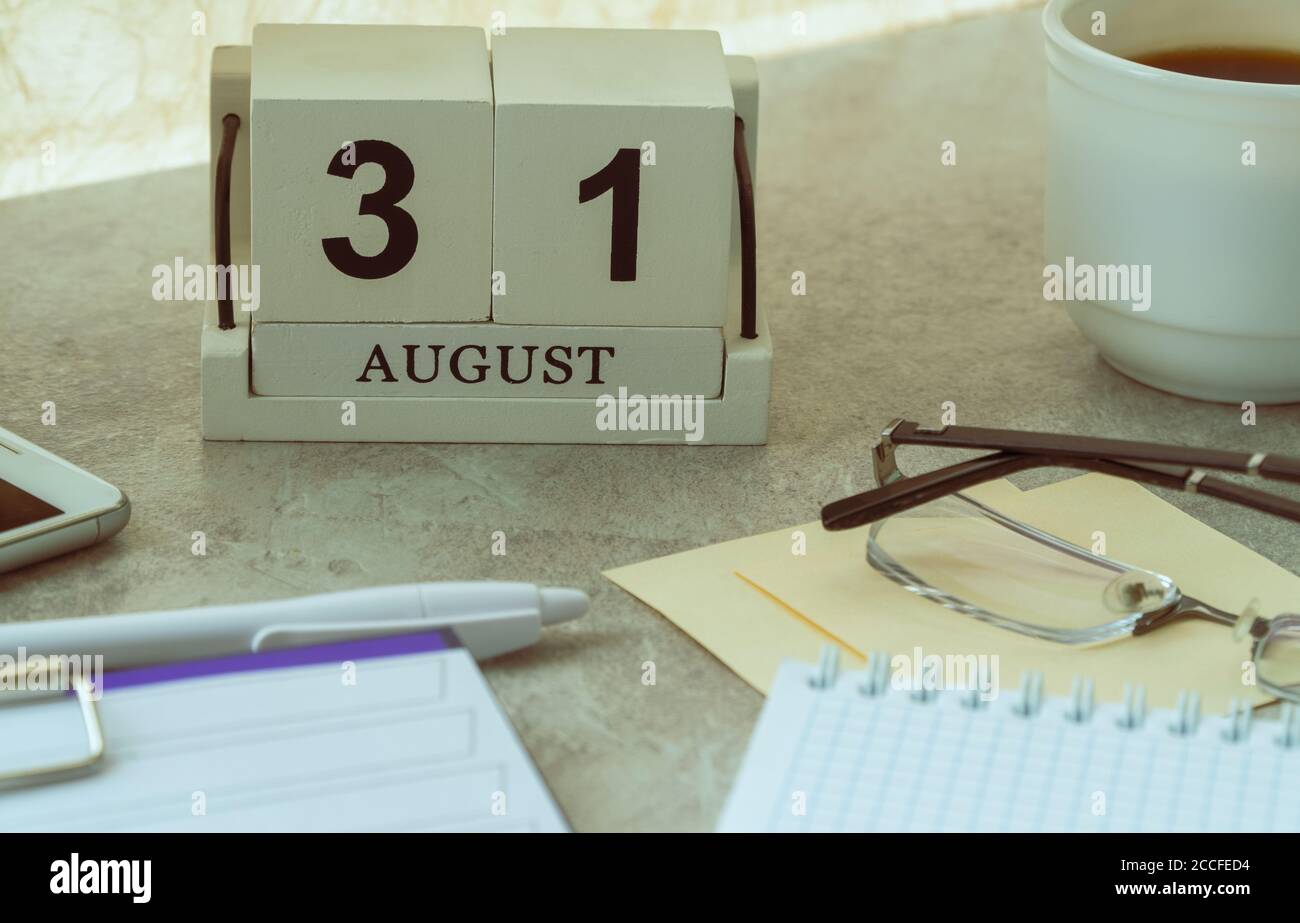 August 31, date on the calendar. Handmade wood cube with date month and ...