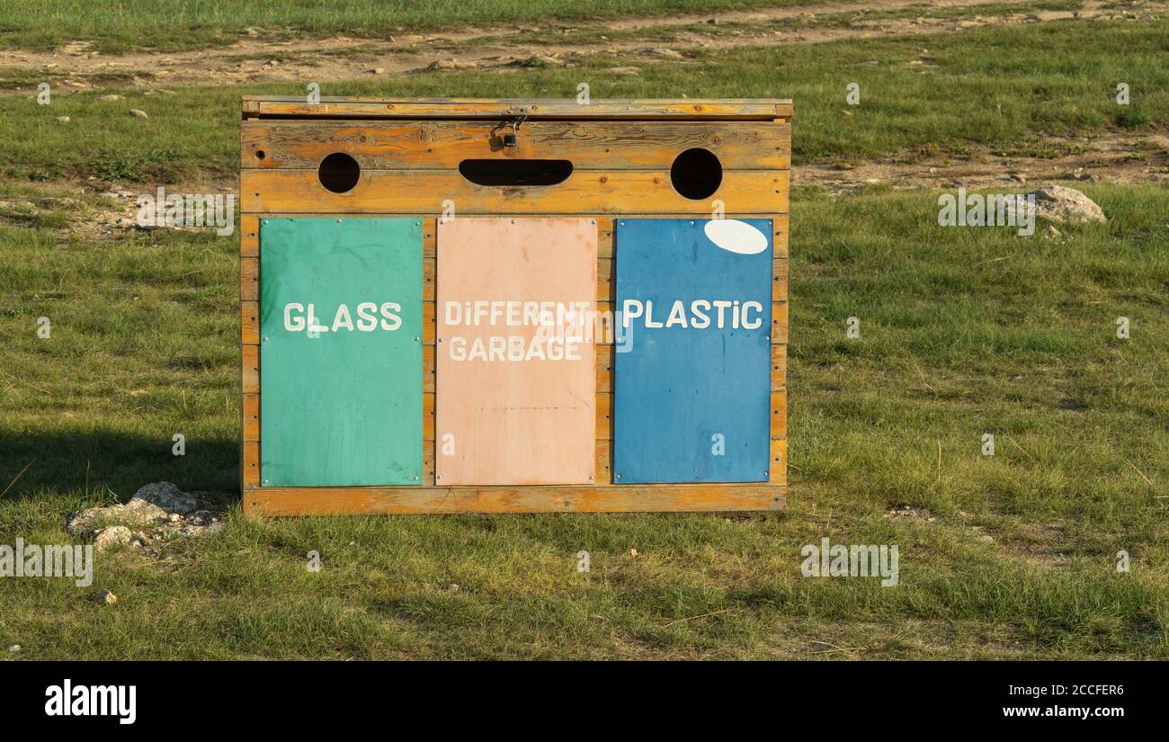 Containers for separate waste collection. wooden waste box on the ...