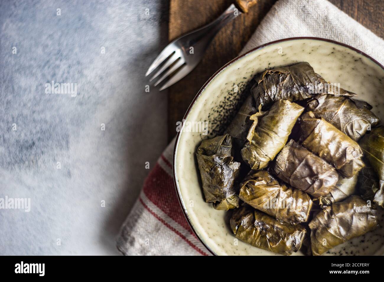 Traditional georgian tolma in vine leaves on rustic background with ...