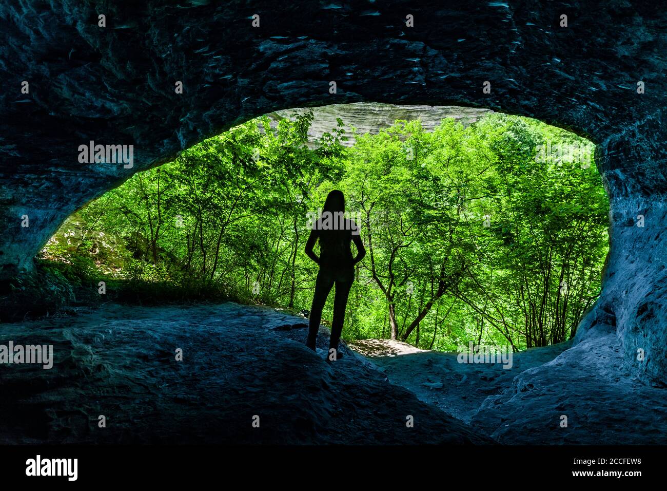 Silhouette of a woman in a cave Stock Photo - Alamy