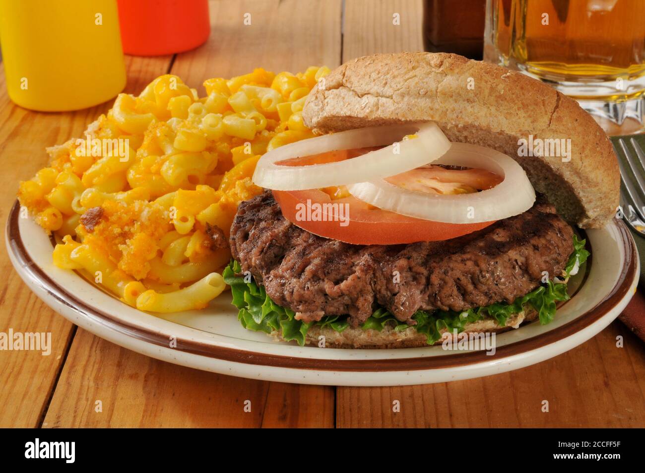 A thick grilled hamburger with macaroni and cheese Stock Photo - Alamy