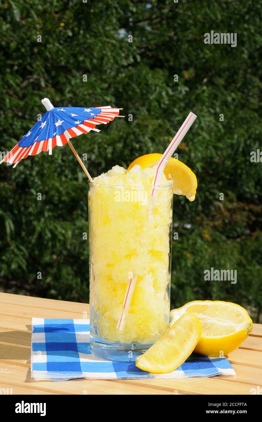 Tall glass of frozen lemonade on the patio Stock Photo - Alamy