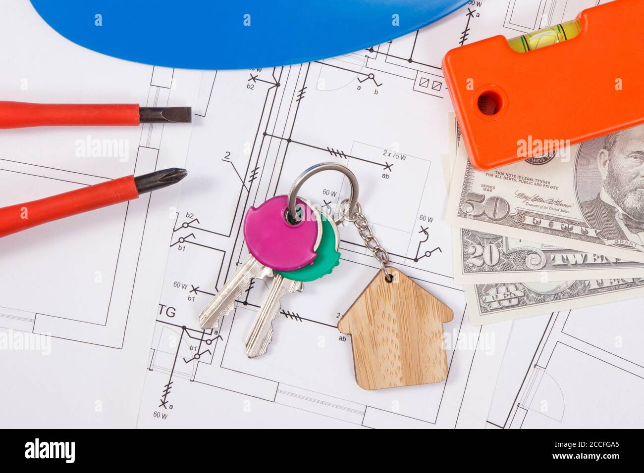 Keys with house shape, currencies dollar and electrical construction ...