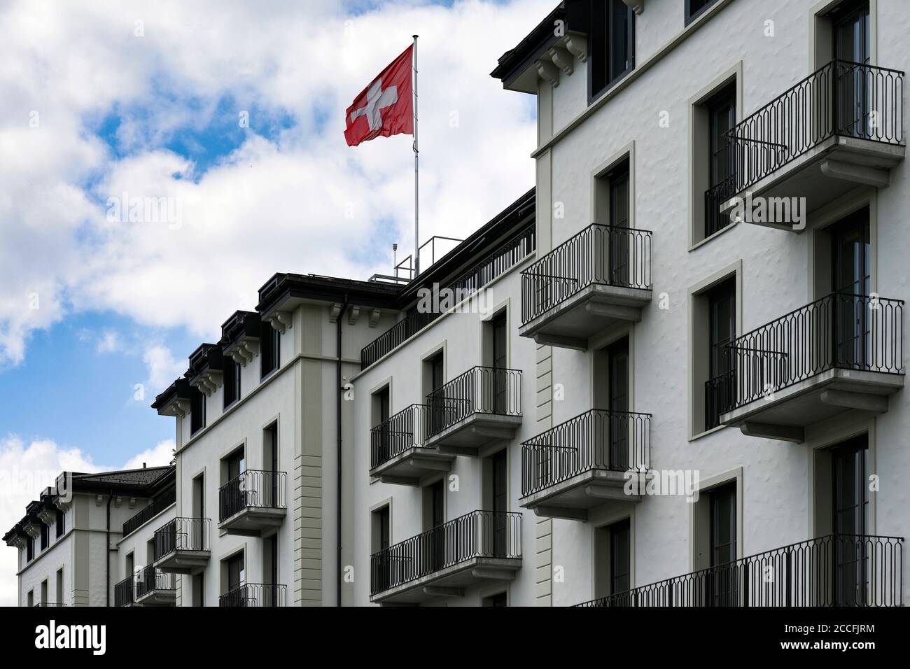 Building facade with Swiss flag Stock Photo - Alamy