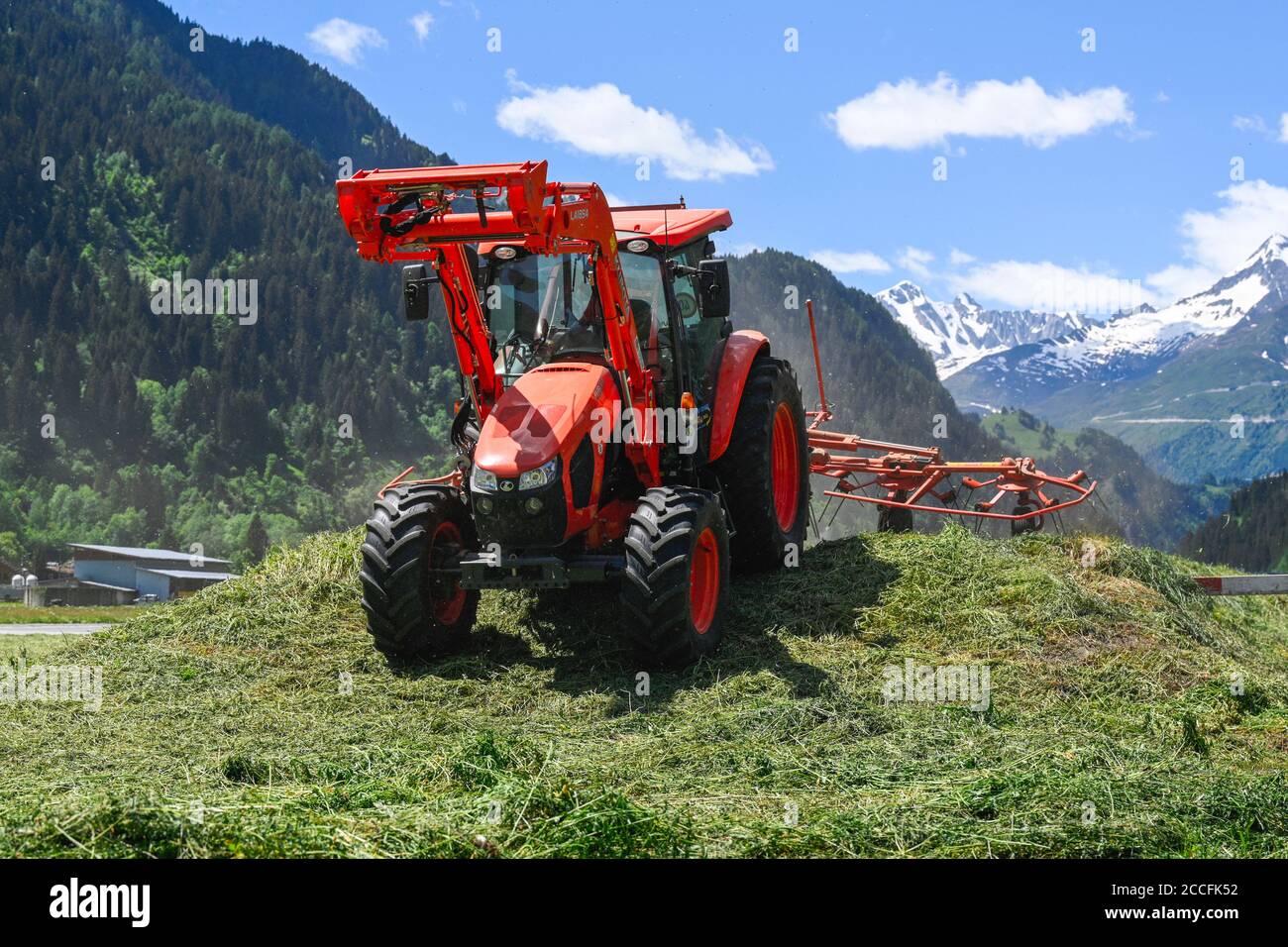 Tractor with rotary swather, Switzerland Stock Photo - Alamy