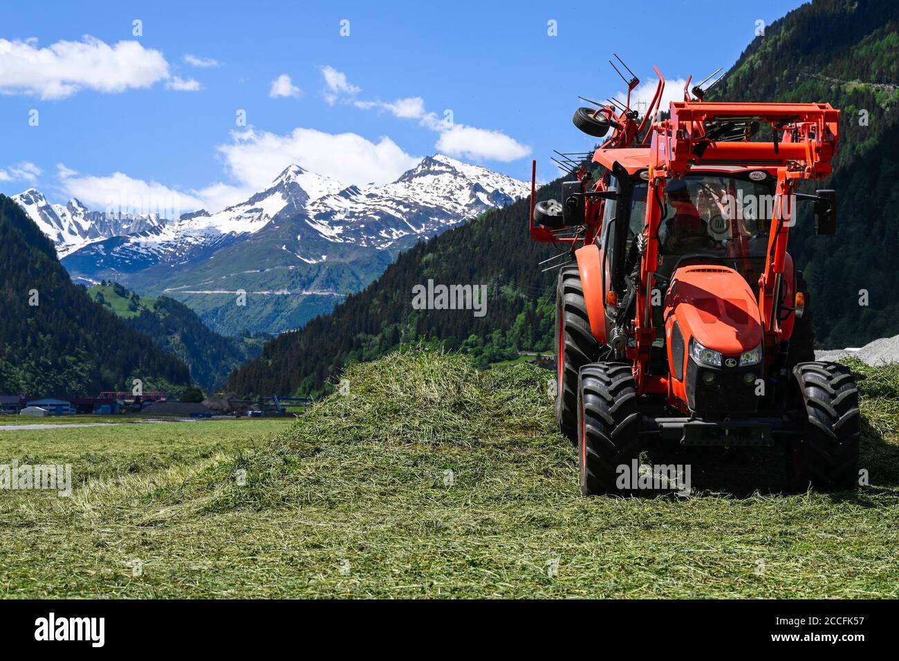 Tractor with rotary swather, Switzerland Stock Photo - Alamy