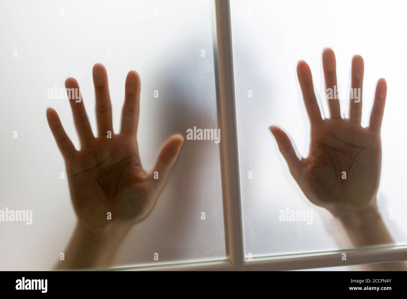 Hand against glass hi-res stock photography and images - Alamy