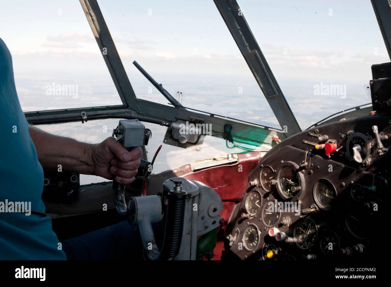 A pilot hand gripping old aircraft wheel while flying Stock Photo - Alamy