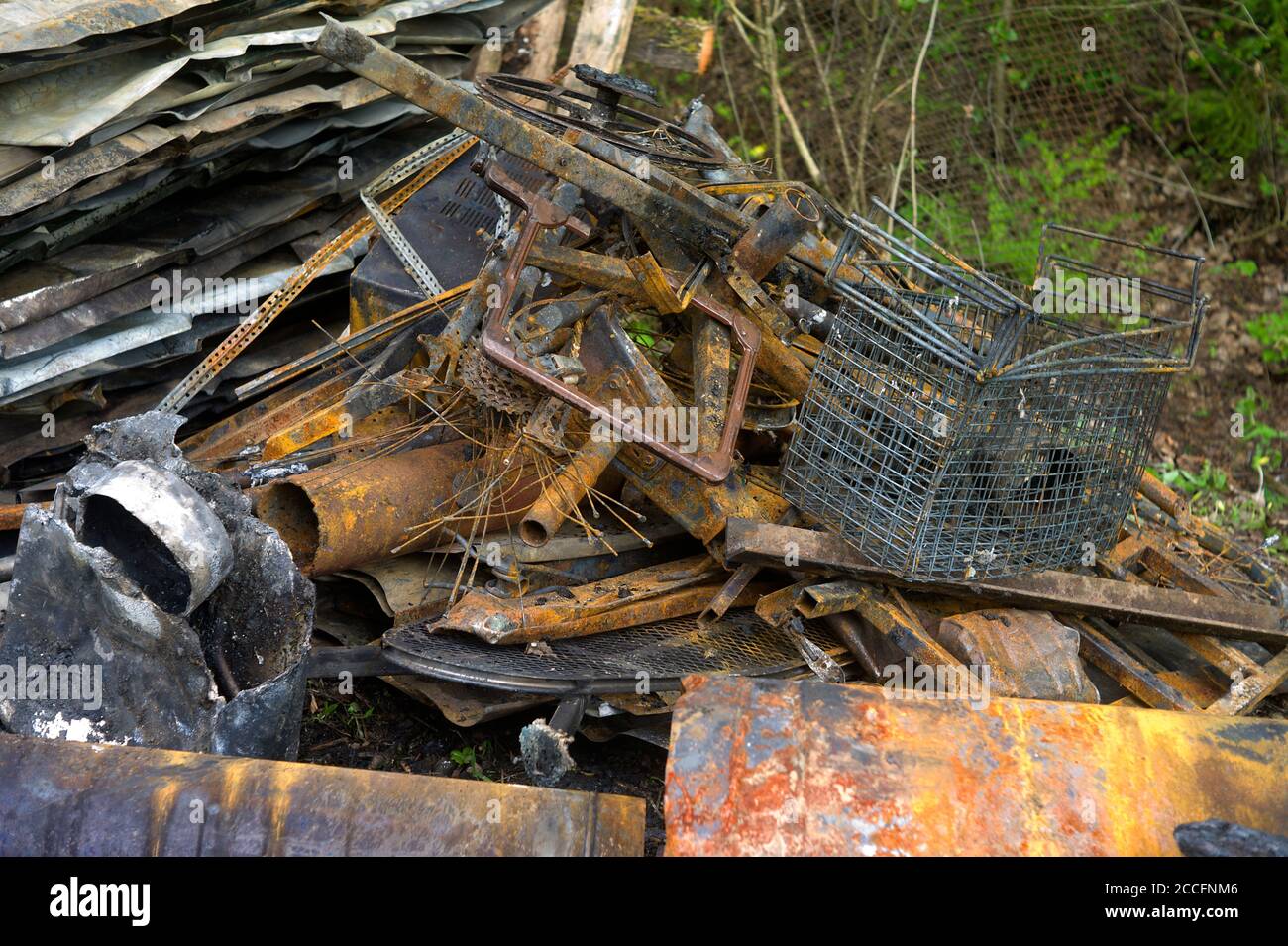 Burned metal scrap abandoned on the ground Stock Photo - Alamy