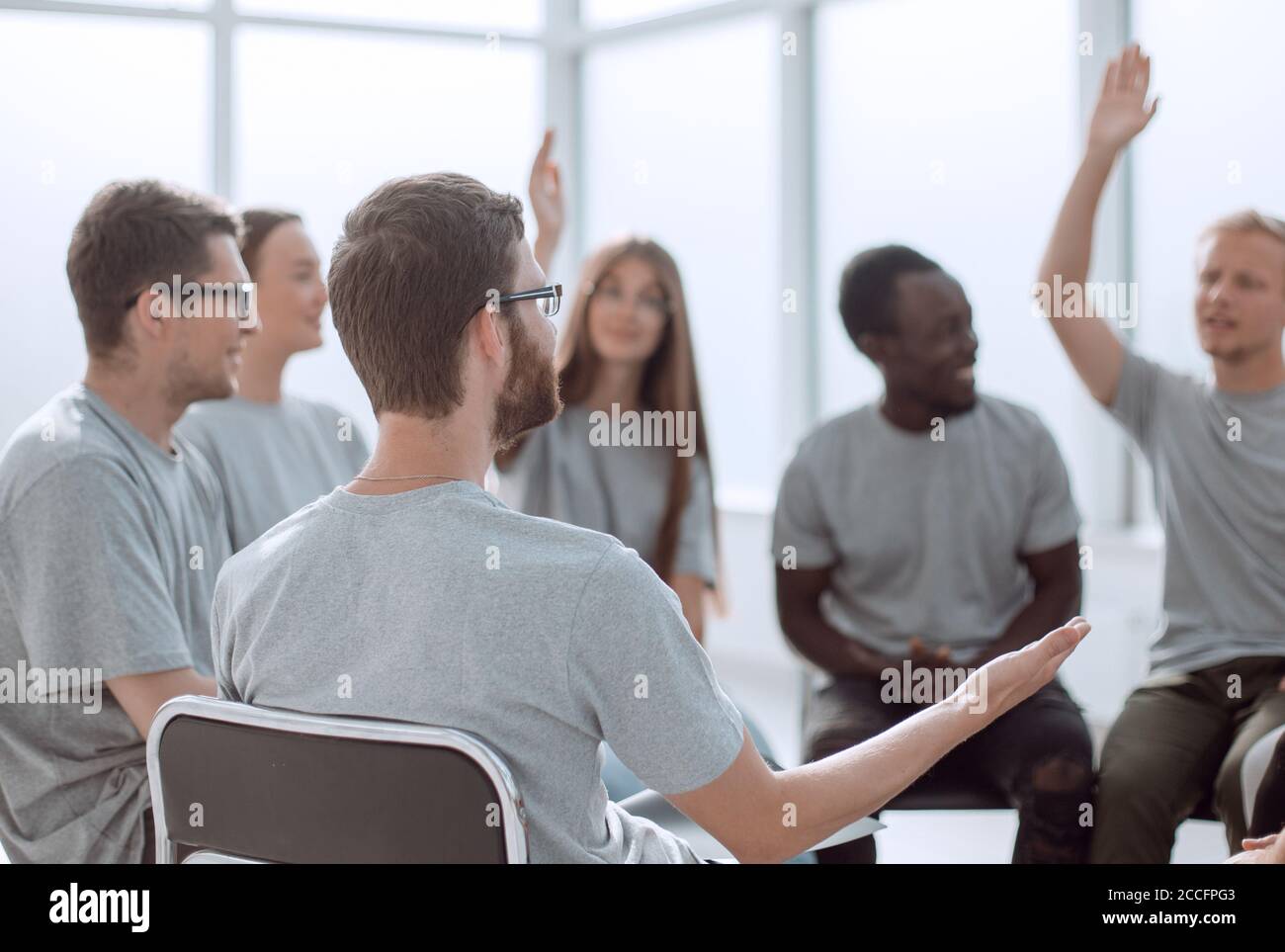 young people ask questions during the meeting Stock Photo - Alamy