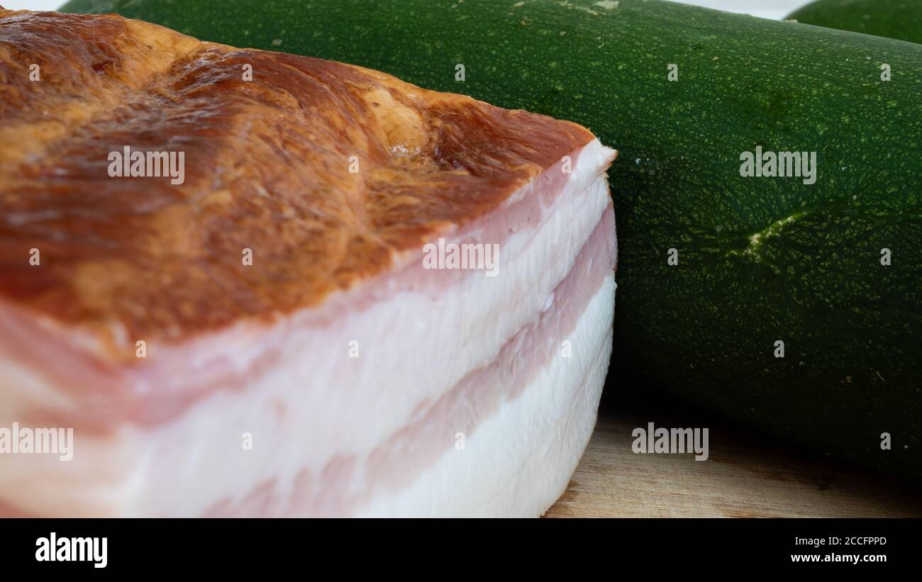 Smoked bacon meat with lots of fat on it in closeup. The meat is salt ...
