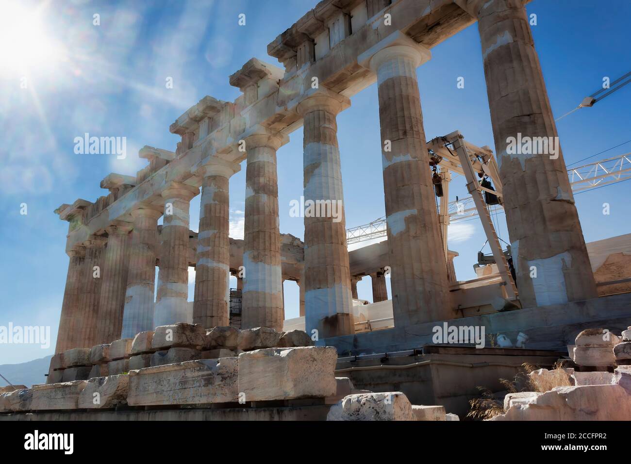 The ruins of the Temple of the Parthenon in the rays of the sun with the blindfolds. Athens ...