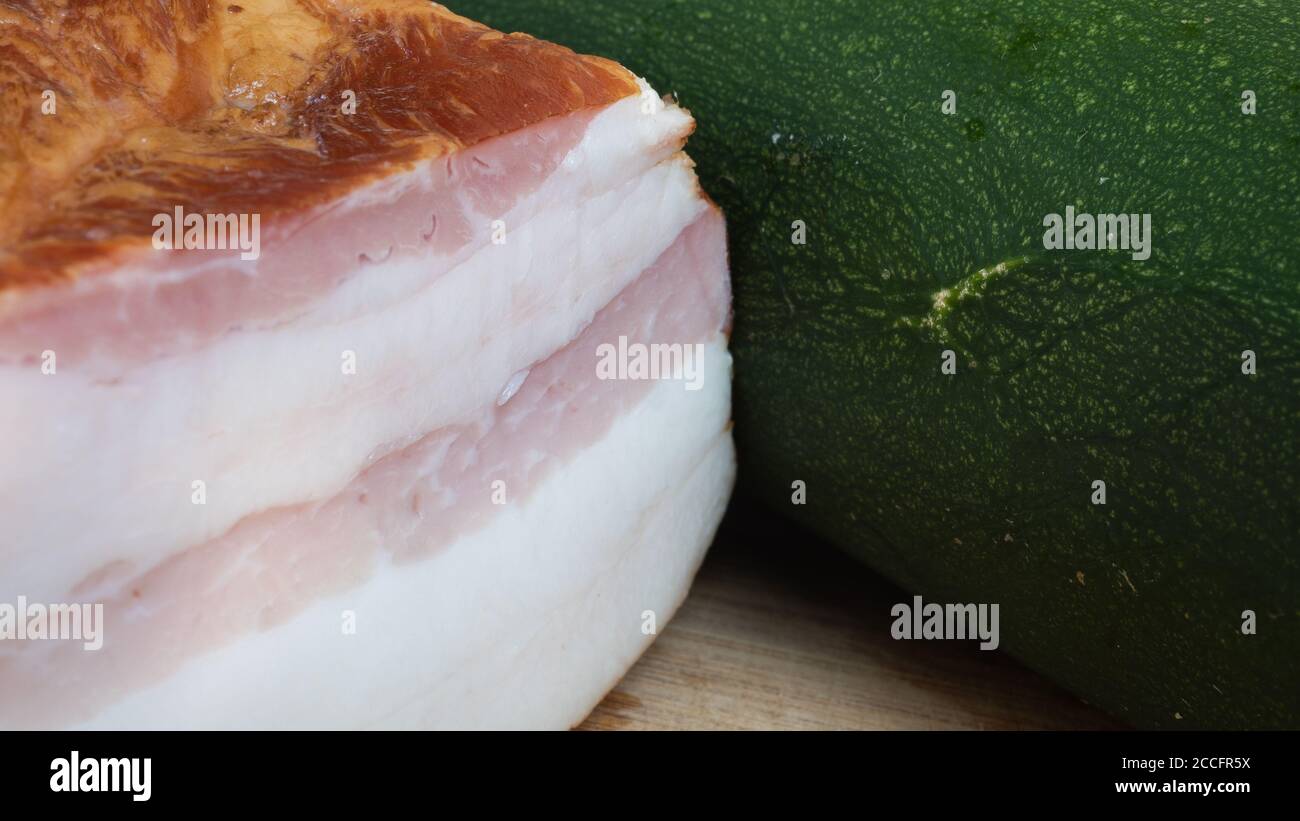 Smoked bacon meat with lots of fat on it in closeup. The meat is salt ...