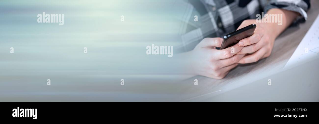 Female hands using a mobile phone; panoramic banner Stock Photo - Alamy
