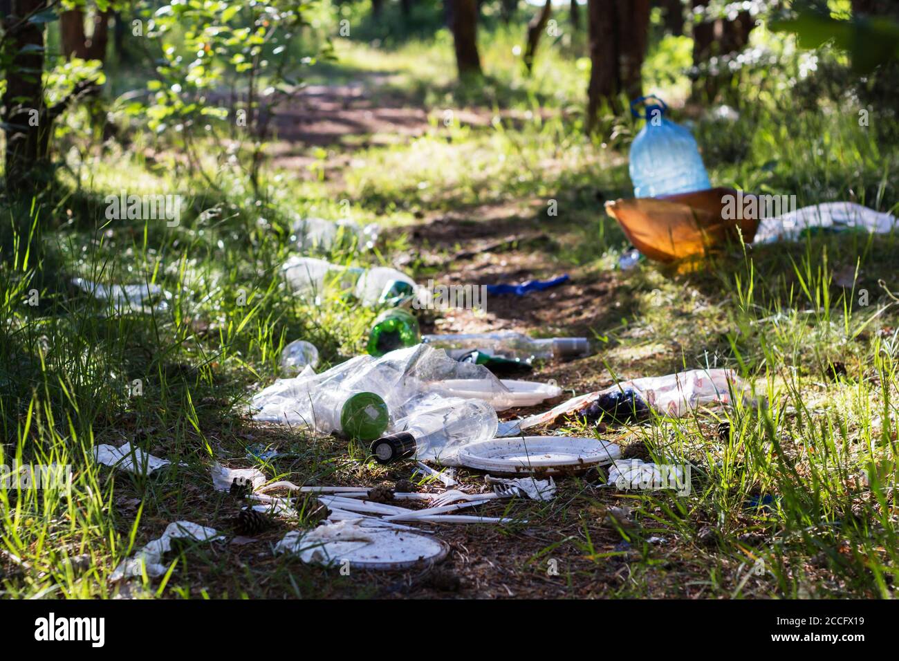 Pile of garbage on green grass Stock Photo - Alamy