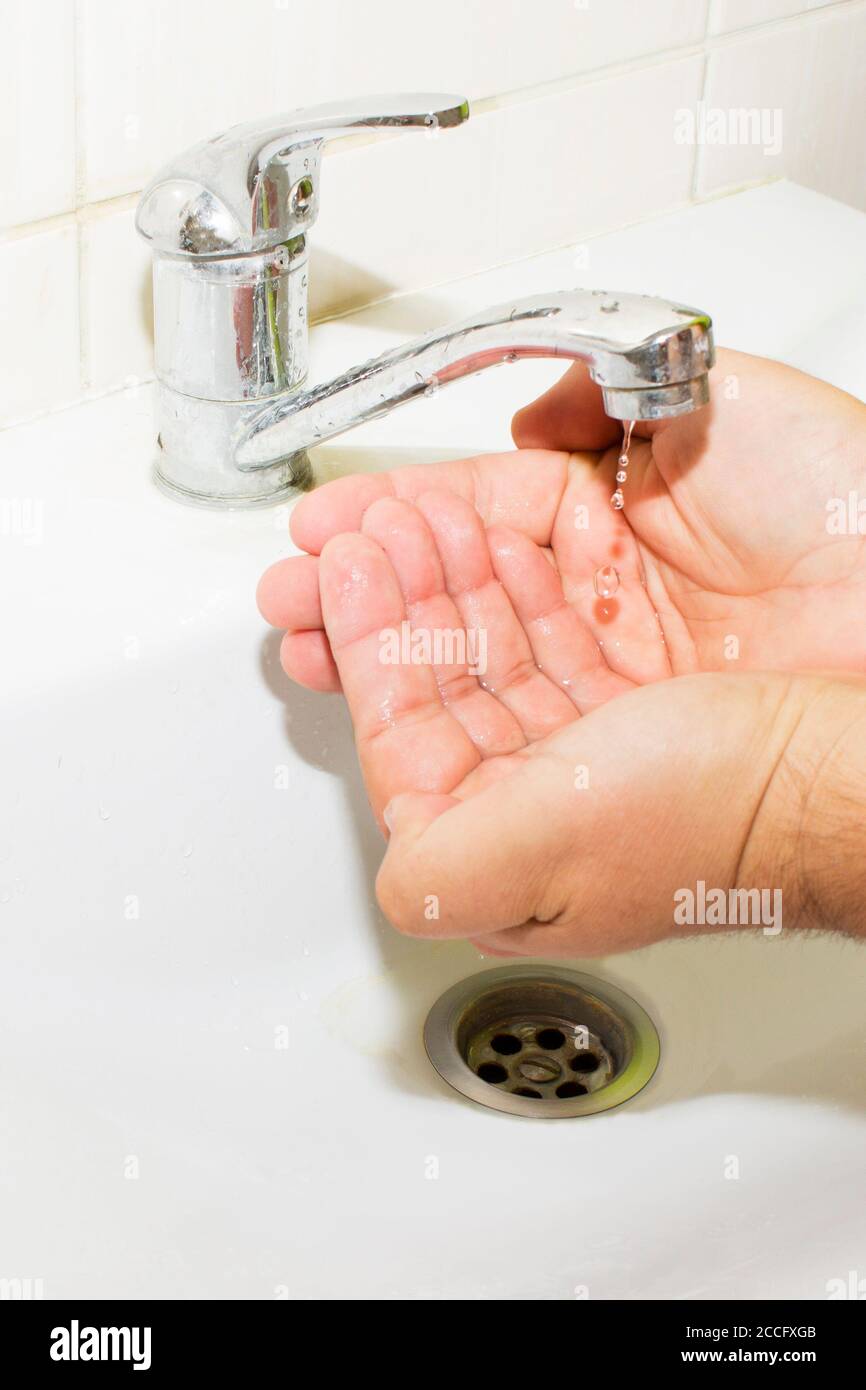 wash basin and running water from the tap in bathroom Stock Photo - Alamy