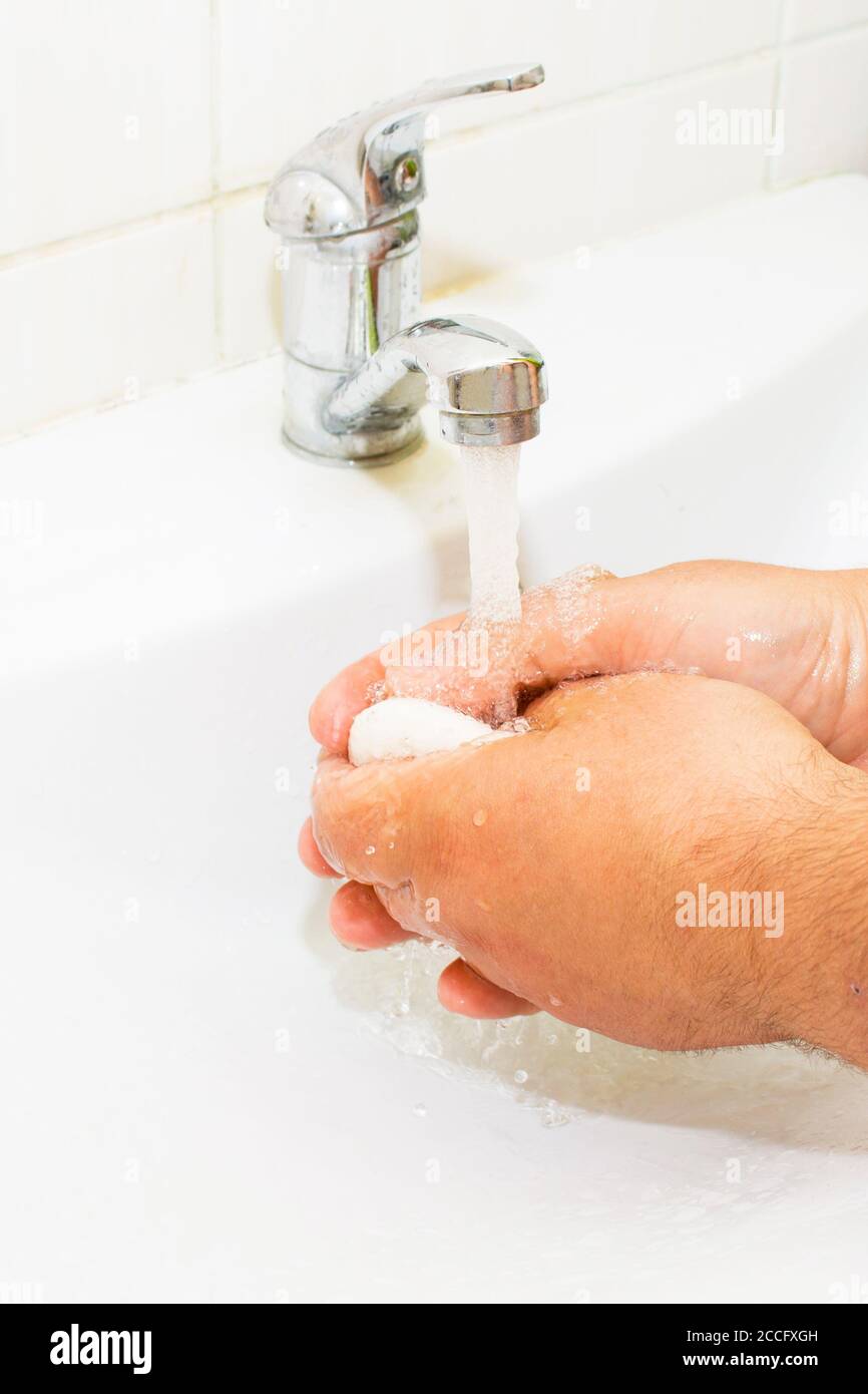 wash basin and running water from the tap in bathroom Stock Photo - Alamy