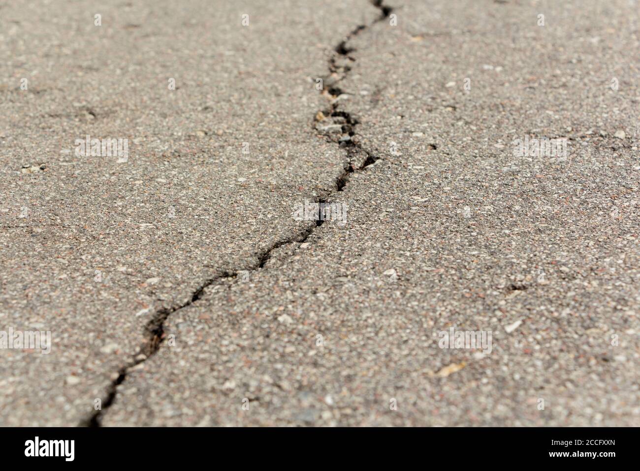 Asphalt with cracks radiating across the surface Stock Photo - Alamy