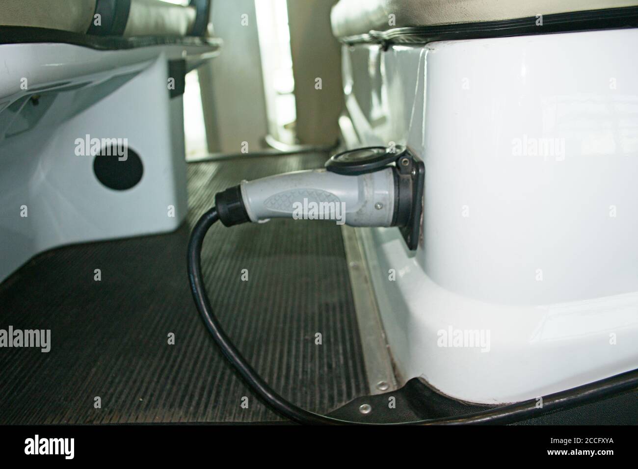 Electric Car is Charging Using a Wired Power Plug. The Concept of ...