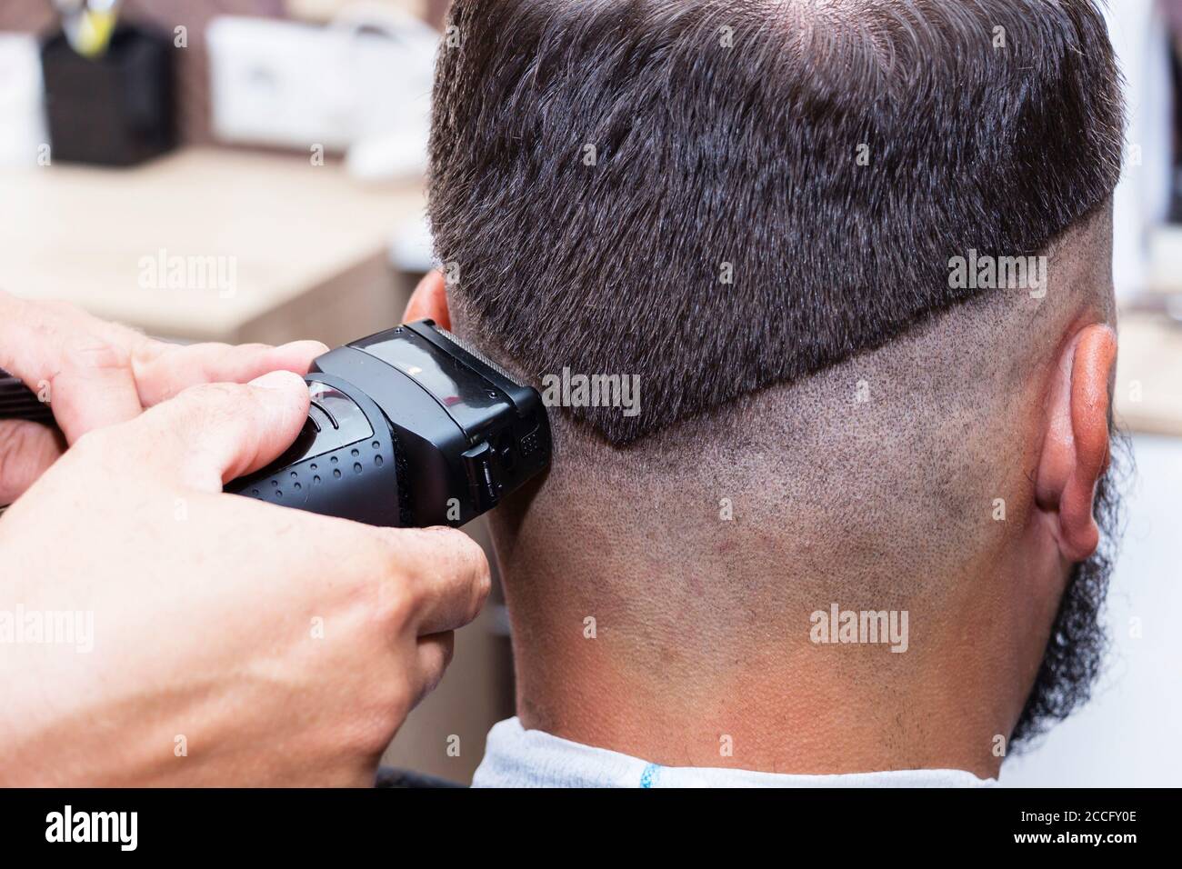 men's hair Styling and grooming with the help of scissors machine and ...