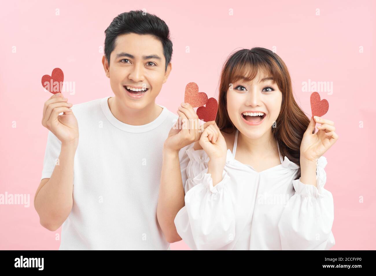 Picture of romantic couple having fun with hearts Stock Photo - Alamy