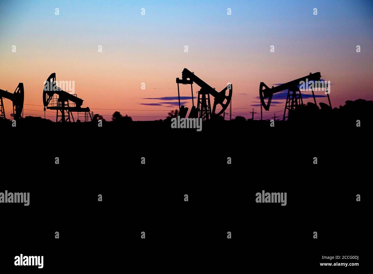 oil rig at sunset, at night, oil production in the world oil market ...