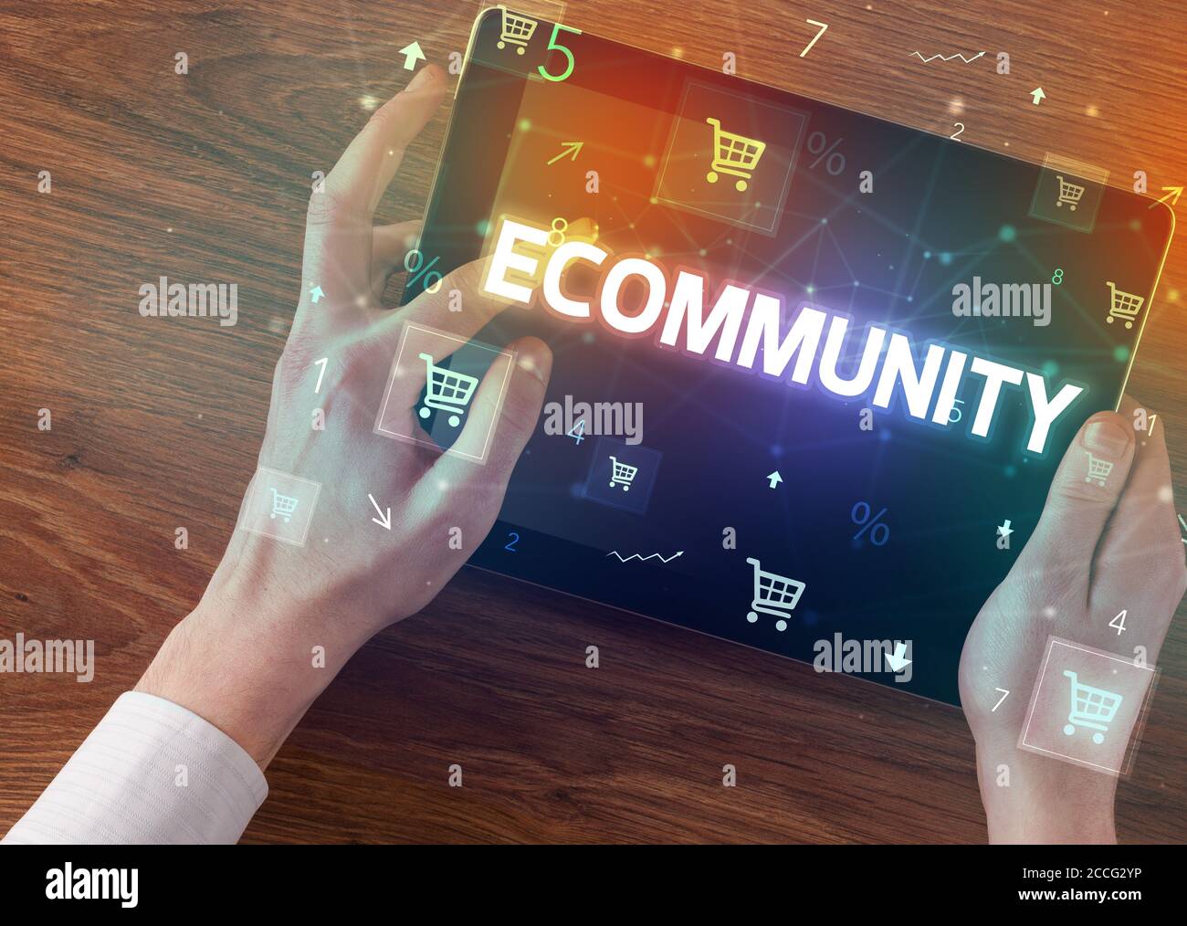 Close-up of a hand holding tablet with ECOMMUNITY inscription, online ...