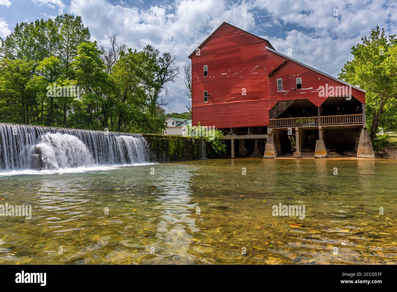 An old red mill by a dam Stock Photo - Alamy