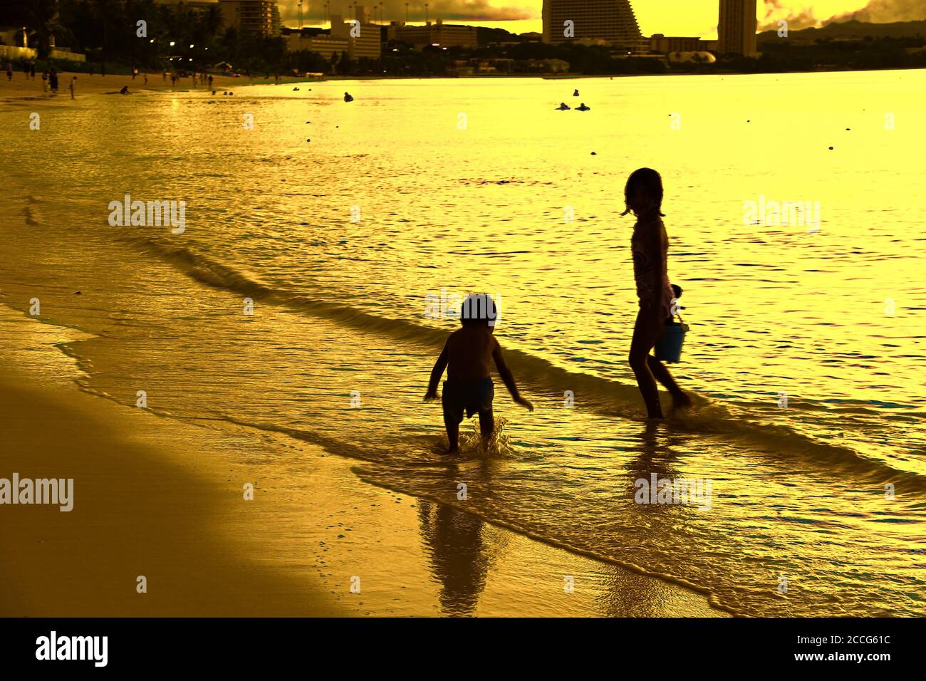 kids on the beach at sunset.happy kids playing on beach at the sunset ...