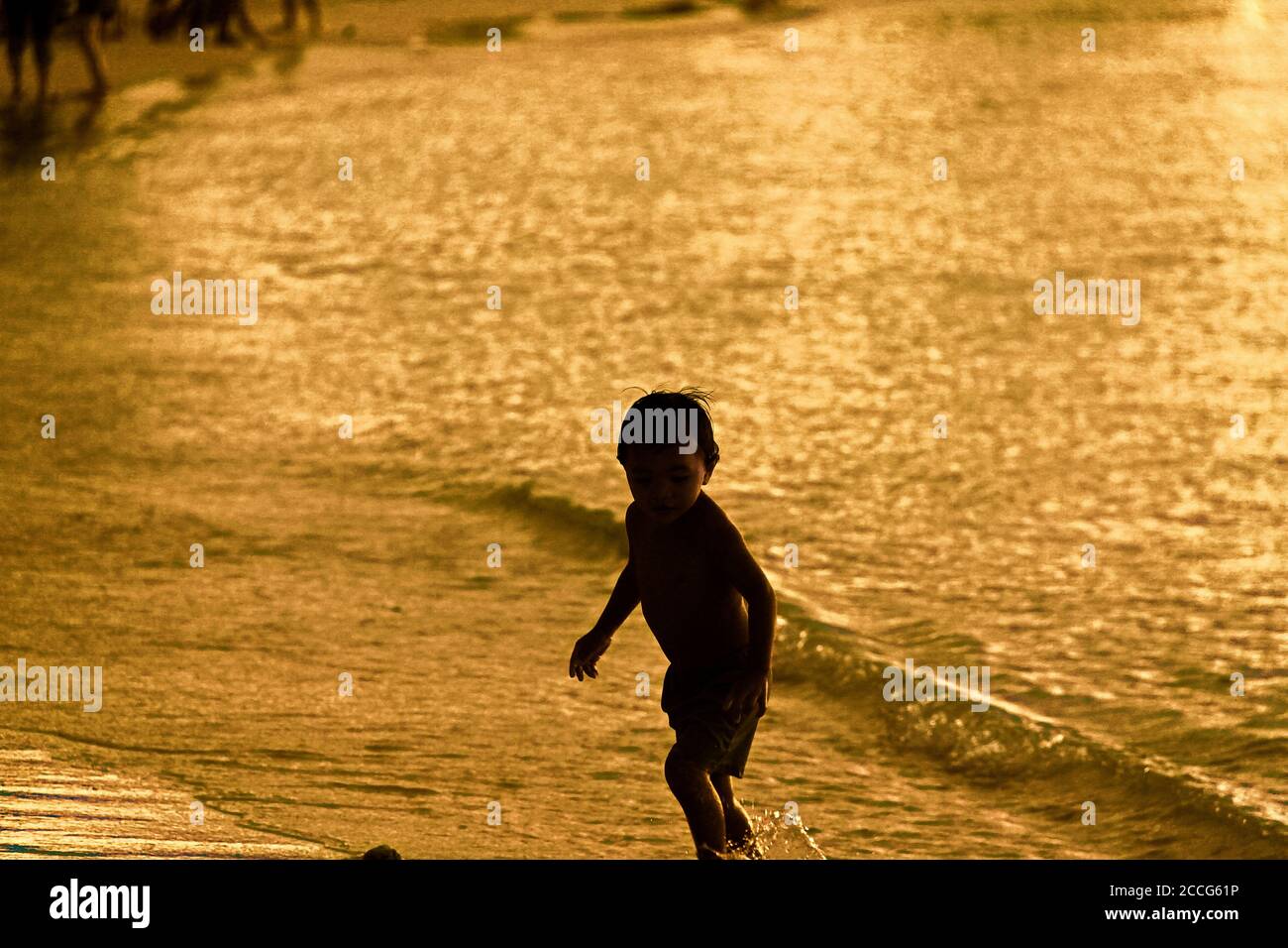 kids on the beach at sunset.happy kids playing on beach at the sunset ...