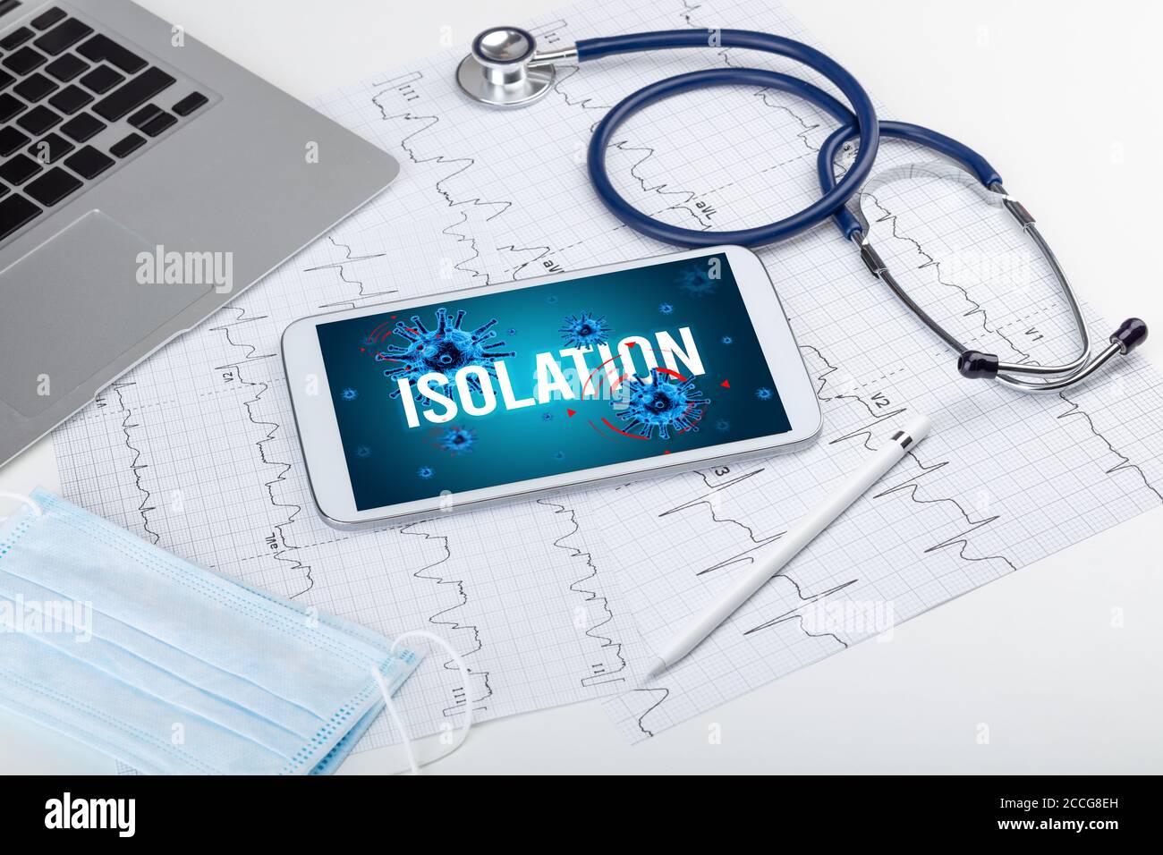 Tablet pc and doctor tools on white surface with ISOLATION inscription ...