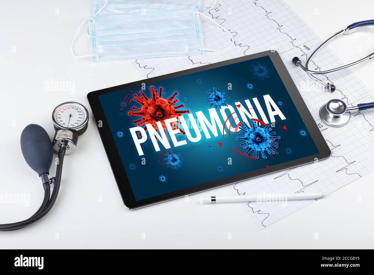 Tablet pc and doctor tools on white surface with PNEUMONIA inscription ...