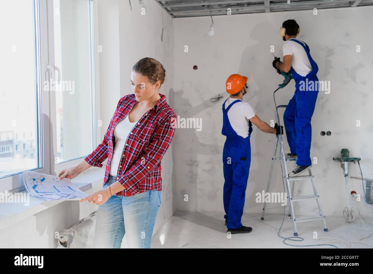 A customer stands by the window and examines the diagram of the house ...