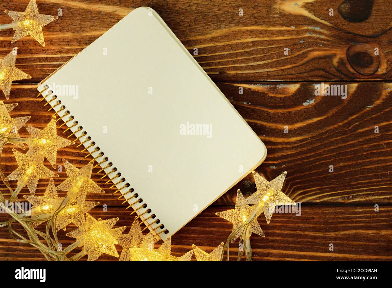Blank sheet of paper with golden decorative stars. New year resolutions ...