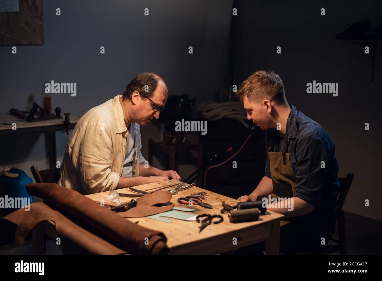 father-shoemaker prepares a successor in the family business of manual ...