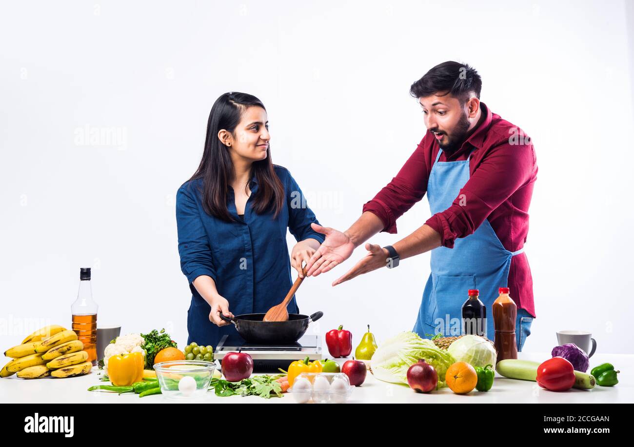 Indian couple in kitchen - Young Beautiful asian wife enjoying cooking ...