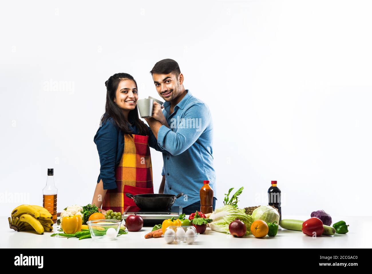 Indian couple in kitchen - Young Beautiful asian wife enjoying cooking ...