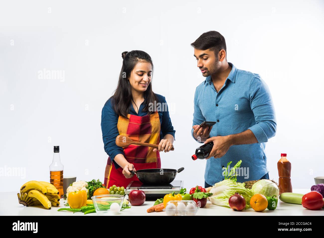 Indian couple in kitchen - Young Beautiful asian wife enjoying cooking ...