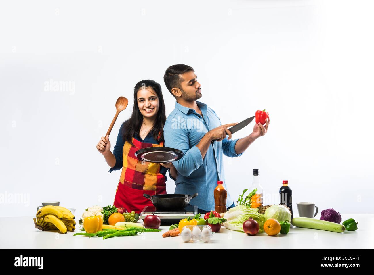 Indian couple in kitchen - Young Beautiful asian wife enjoying cooking ...