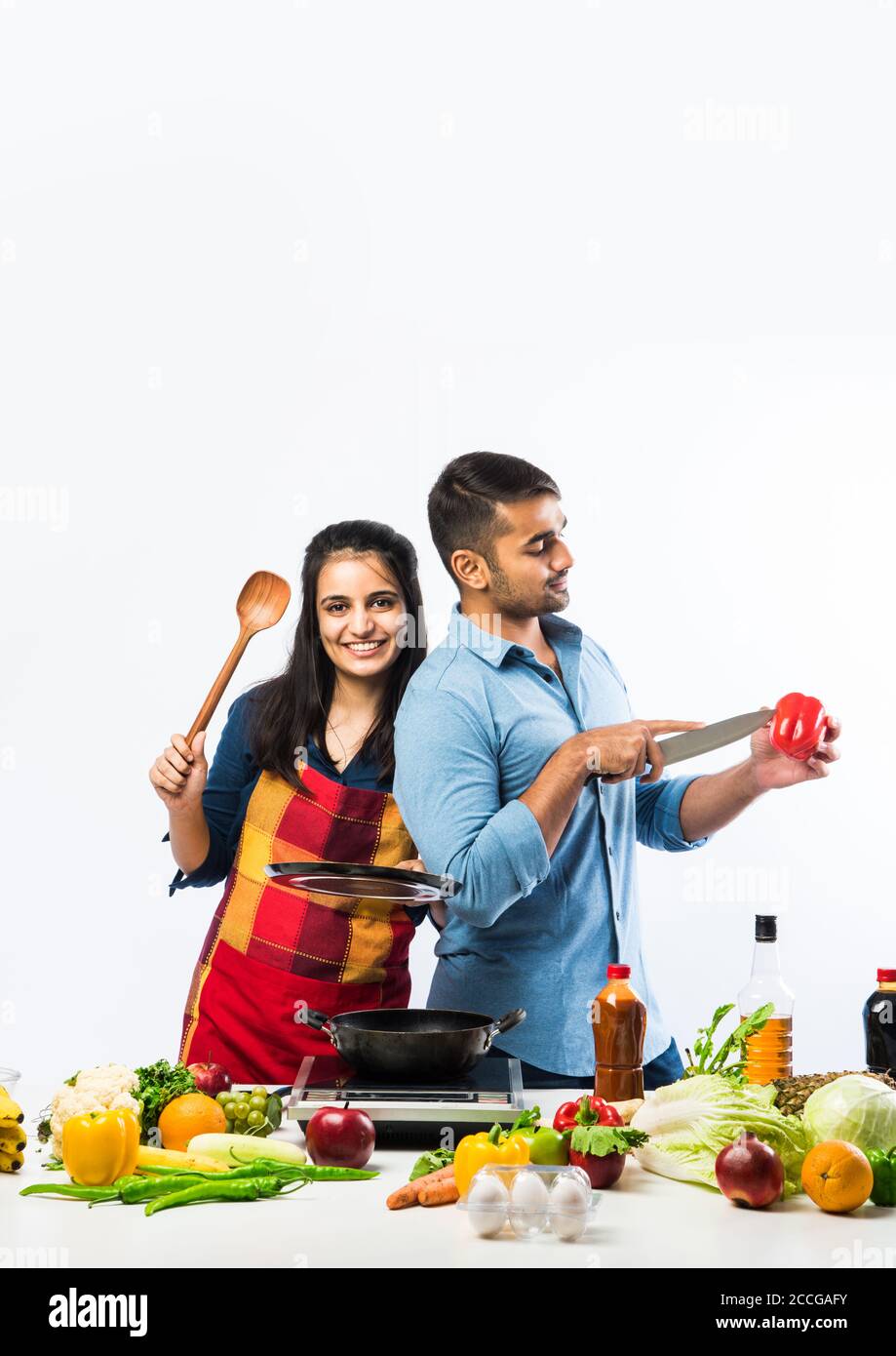 Indian couple in kitchen - Young Beautiful asian wife enjoying cooking ...