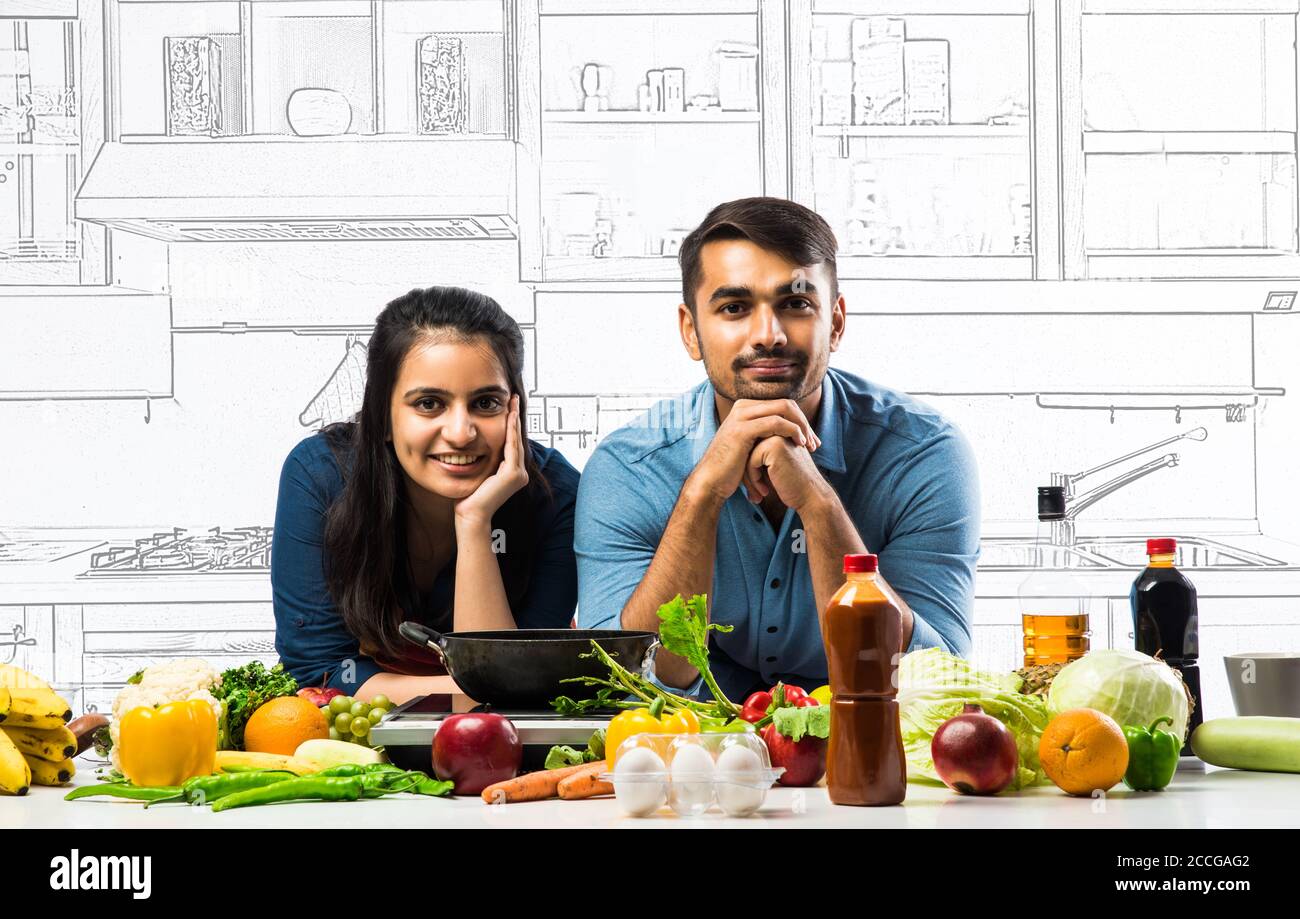 Indian couple in kitchen - Young Beautiful asian wife enjoying cooking ...