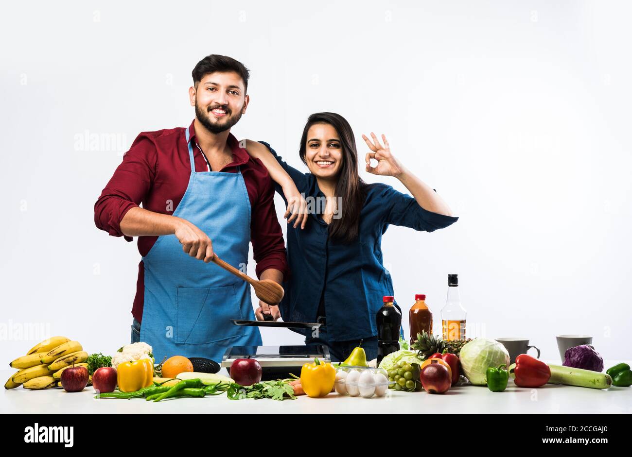 Indian couple in kitchen - Young Beautiful asian wife enjoying cooking ...