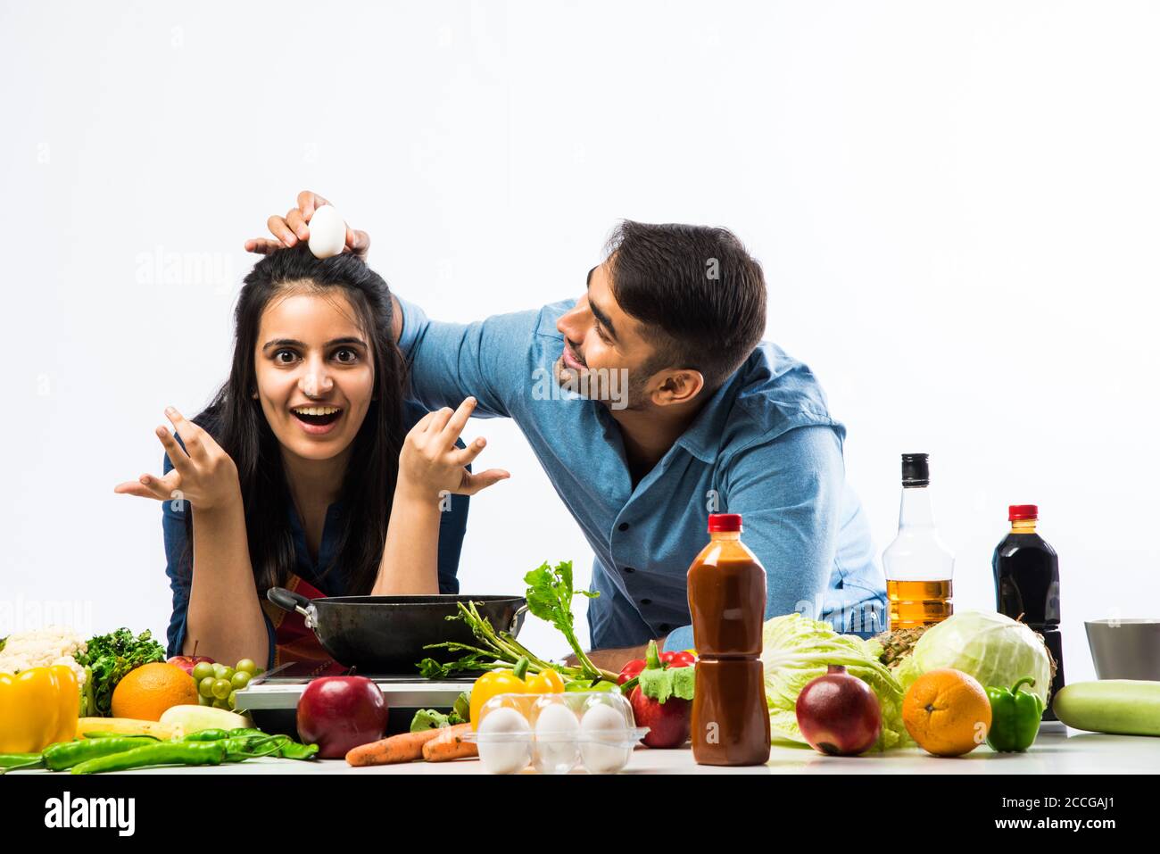 Indian couple in kitchen - Young Beautiful asian wife enjoying cooking ...