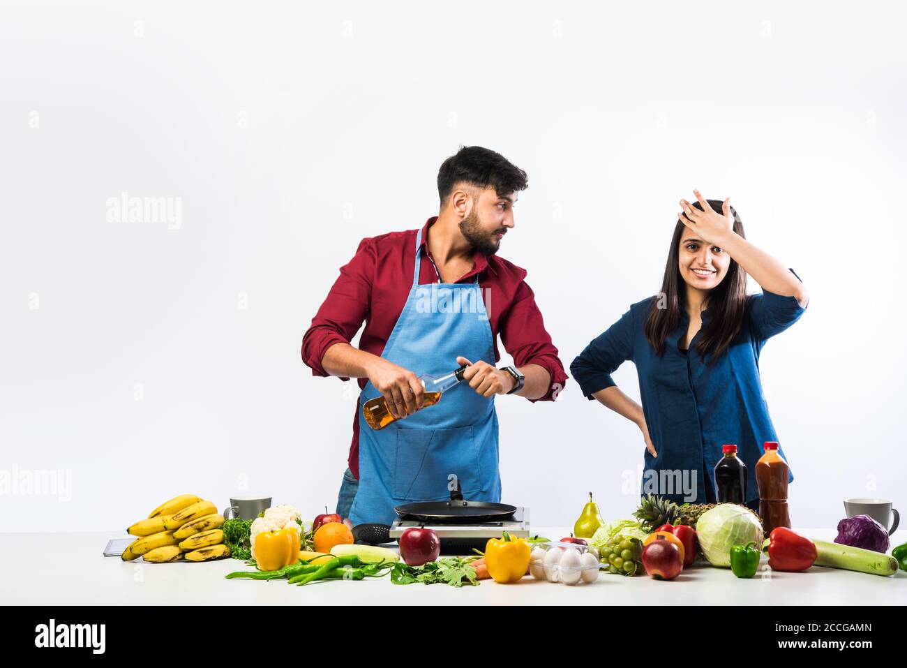 Indian couple in kitchen - Young Beautiful asian wife enjoying cooking ...