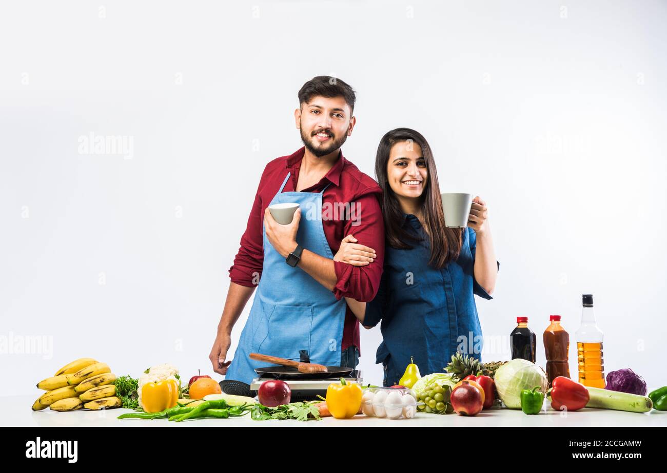 Indian couple in kitchen - Young Beautiful asian wife enjoying cooking ...