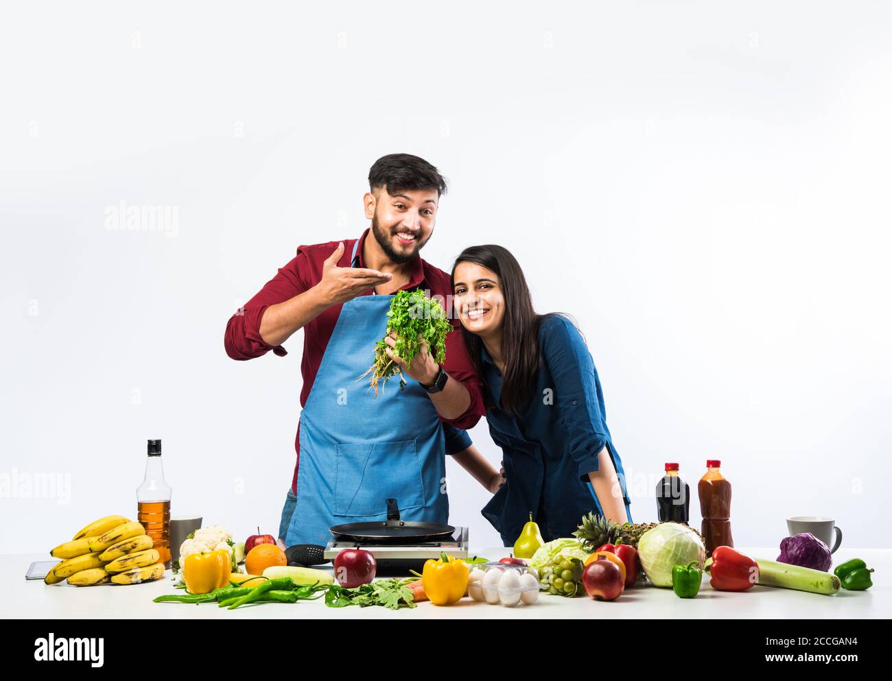 Indian couple in kitchen - Young Beautiful asian wife enjoying cooking ...