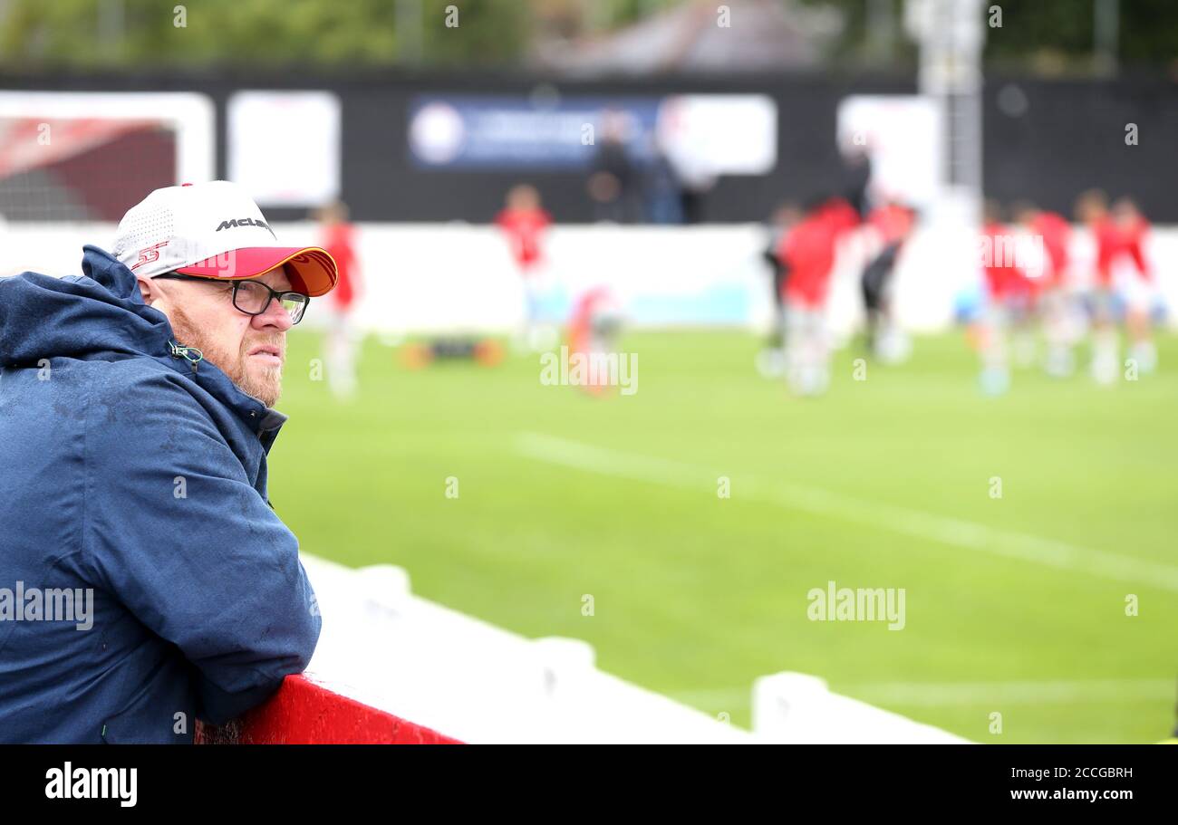 A fan watches the players warm up before the pre-season friendly match ...